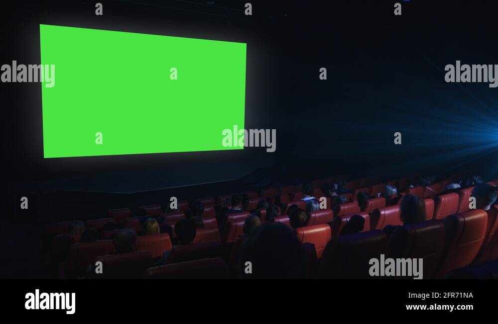 Group of people are watching a green screen mock-up film screening in a ...