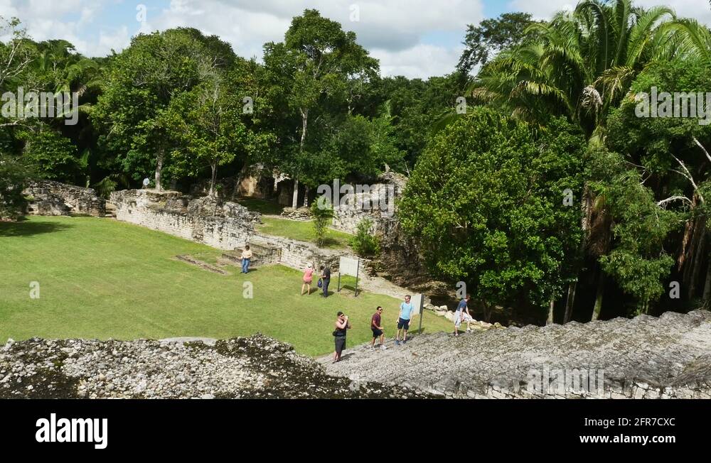Tourists visit and climb temple steps at ancient Mayan ruins in Costa ...