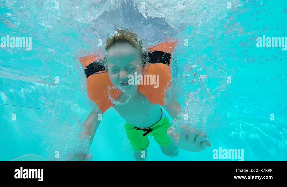 UNDERWATER SLOW MOTION: Young boy child jumping into water Stock Video ...