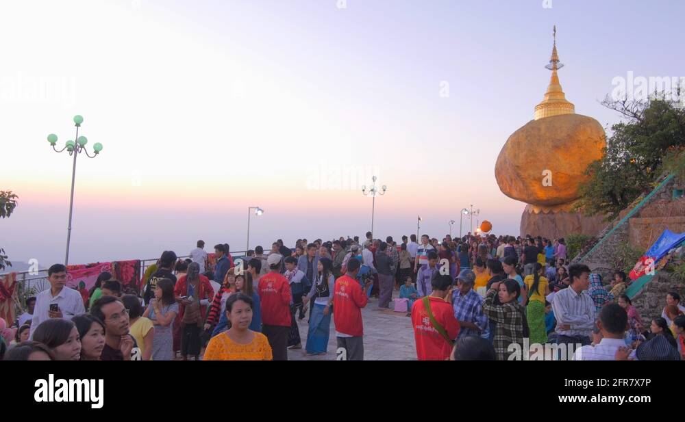 Many Buddhist pilgrims on holy site of Golden Rock pagoda in Myanmar ...