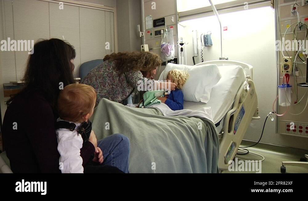 Nurse helping little boy in hospital bed Stock Video Footage - Alamy