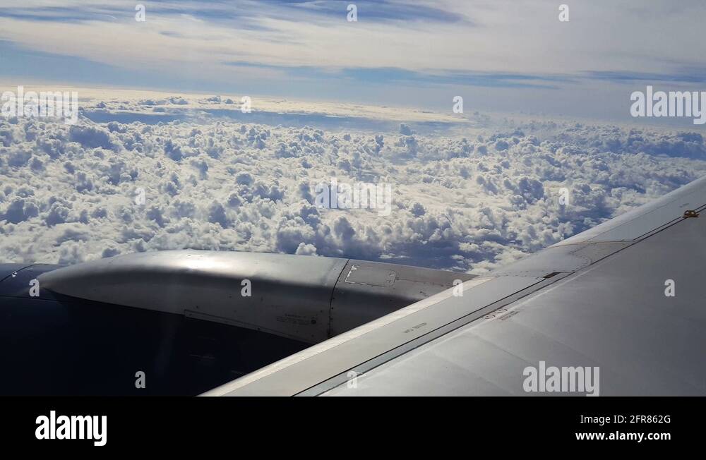 POV-Airline descending toward solid cumulus cloud layer with stratus ...