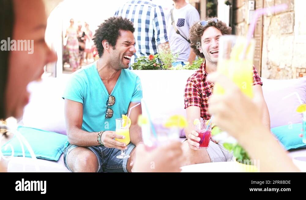 Two male friends drinking cocktails on terrace cafe in summer Stock ...