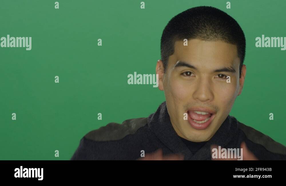 Young man makes funny faces, on a green screen background Stock Video ...