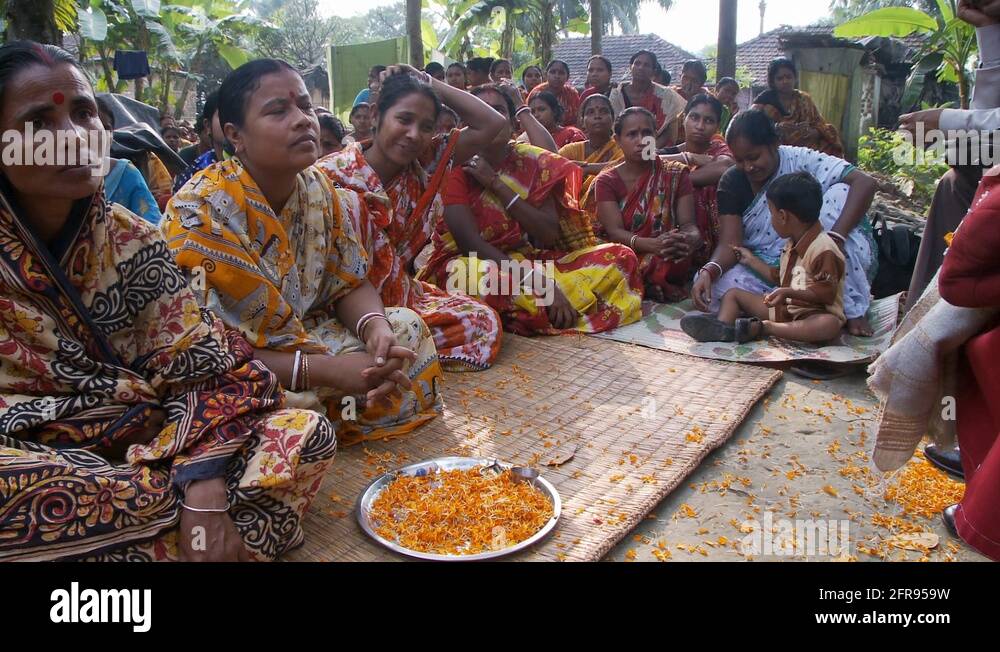 Small crowd of Indian women sitting on the ground listening Stock Video ...