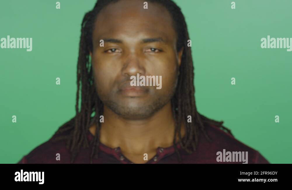 black man with dreads looking sad, on a green screen background Stock ...