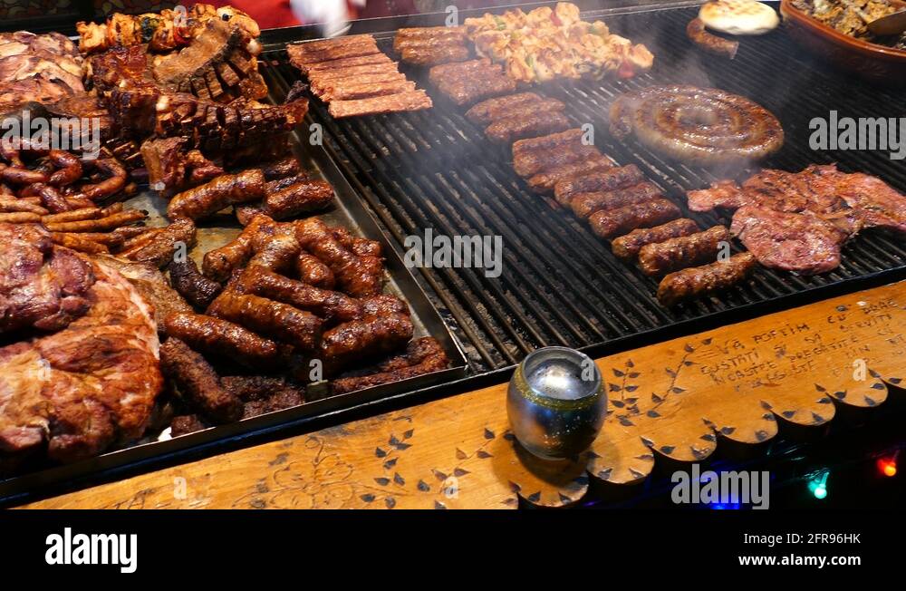 Romanian traditional sausages -mici- skewers and grill steaks Stock ...