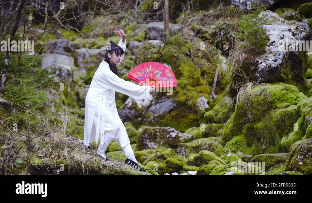 Woman in white kimono make pose with red Chinese fan in nature 4K Stock ...