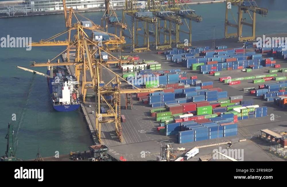 4K Pan right industrial port cargo ship load container shipyard storage ...