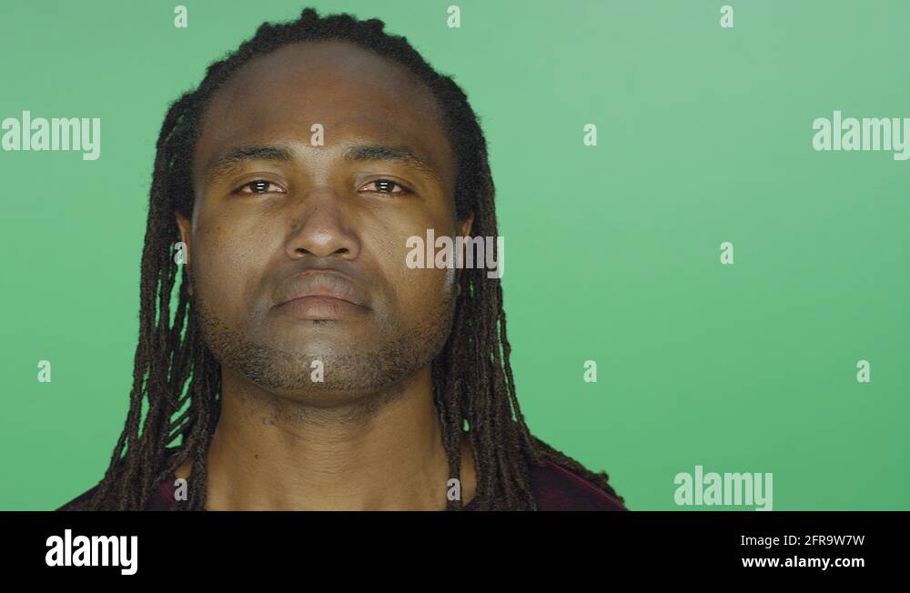 black man with dreads looking sad, on a green screen background Stock ...
