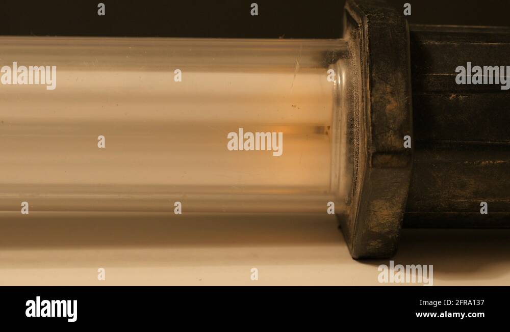 Flickering CFL Lightbulb tube on a black background, 4K Stock Video ...