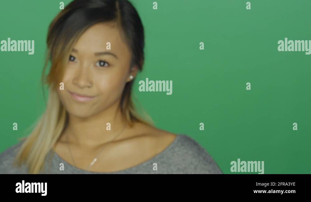 Cute Asian girl smiling shyly, on a green screen background Stock Video ...