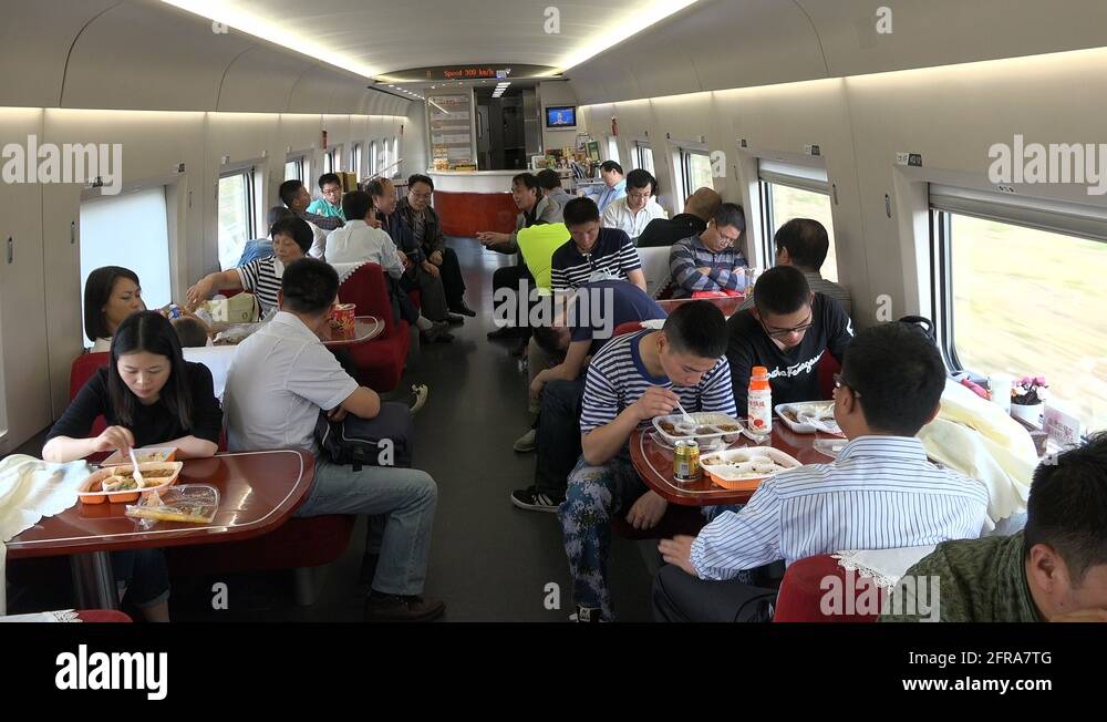 People eat lunch in dining car of fast riding high speed bullet train ...