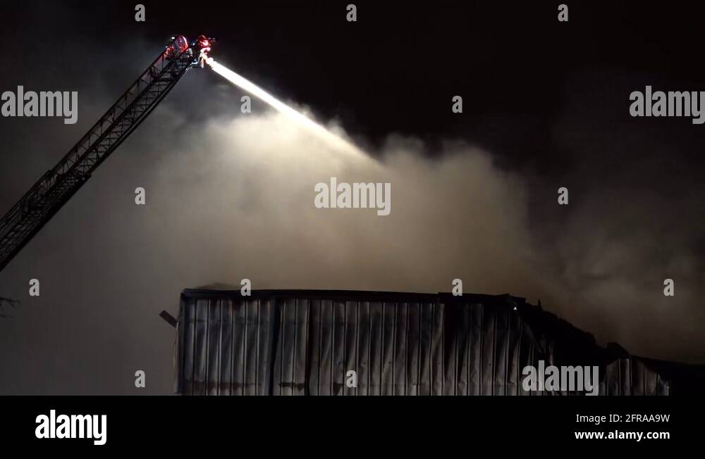 Ladder Truck Spraying Water On A Building During A 4 Alarm Fire Stock ...