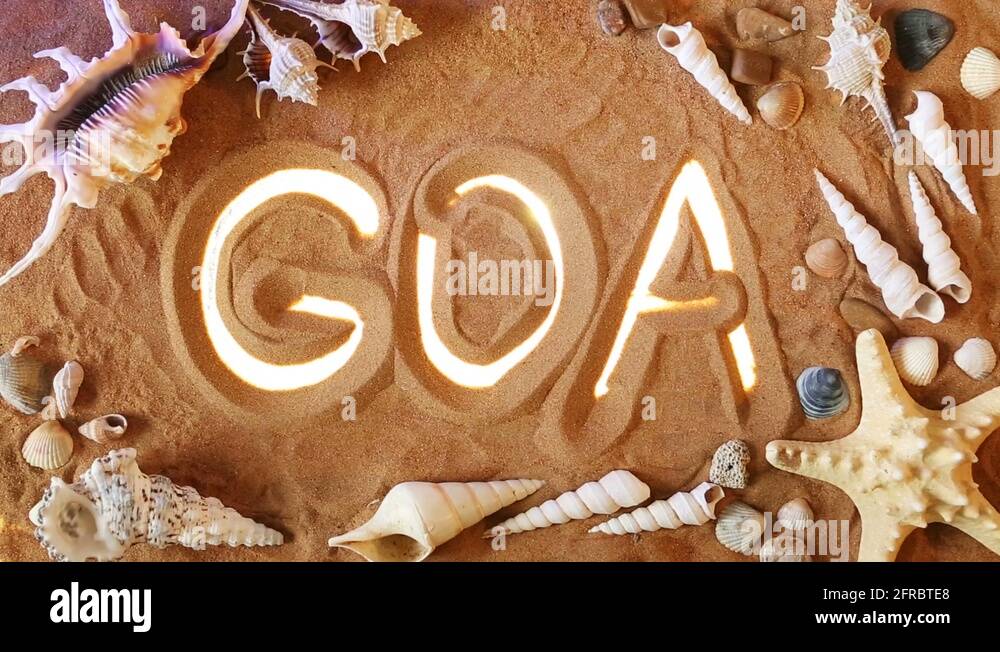 Hand drawing Goa symbol in the sand. Beach background. Top view Stock ...