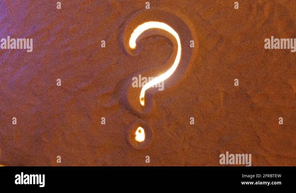 Hand drawing Question mark symbol in the sand. Beach background. Top ...