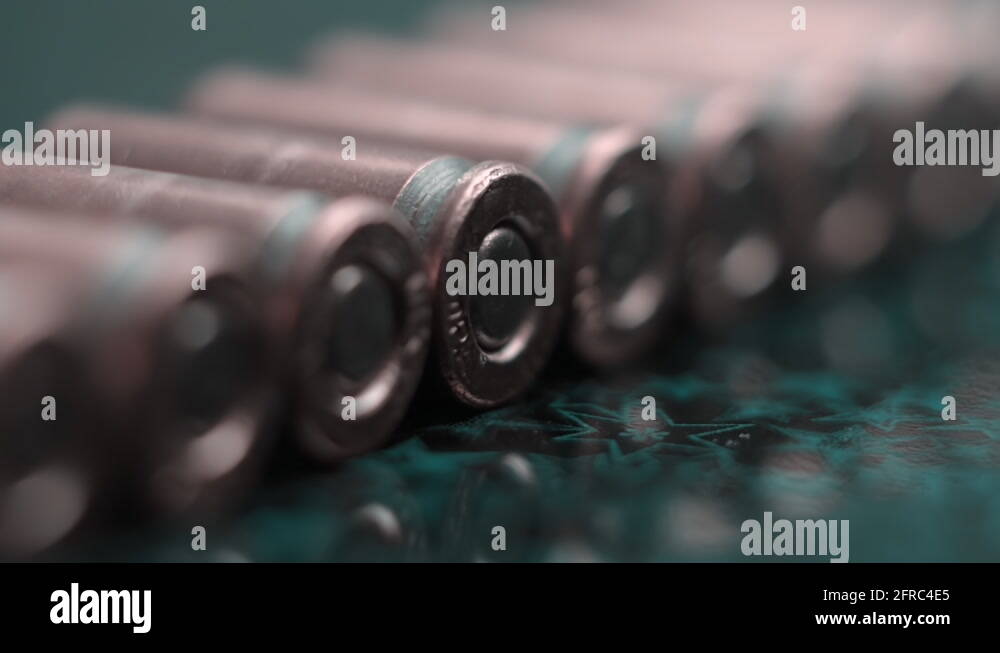 Row of new, not shooting bullet caliber 9mm on reflective surface ...