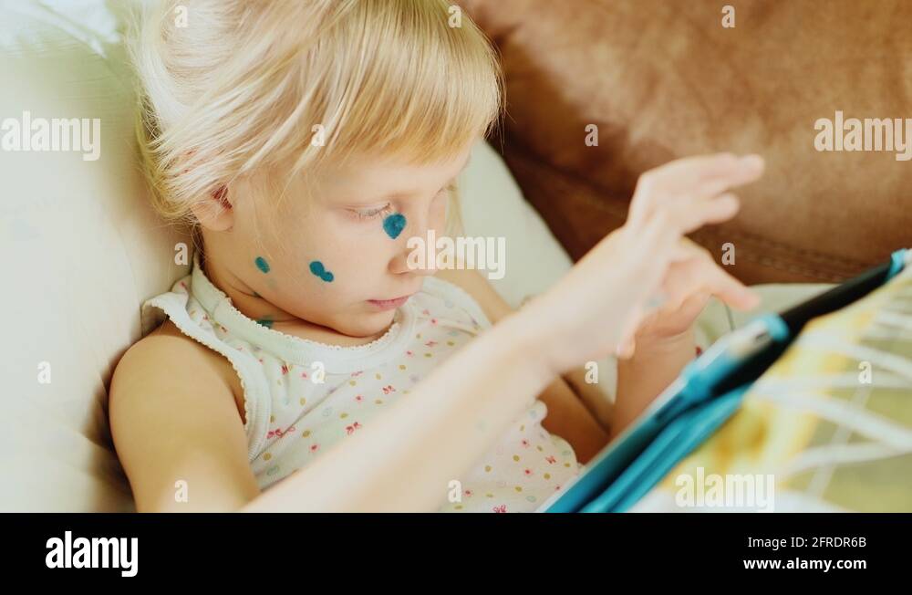 Sick chicken pox girl lying in bed, playing on your tablet Stock Video ...