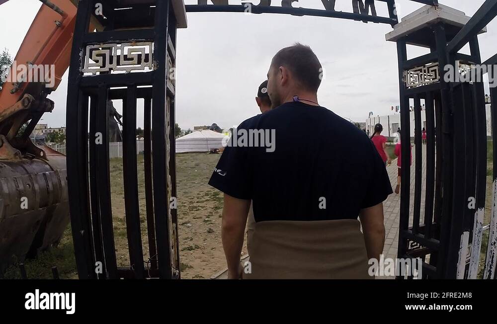 People Pass Through a Passage in an Iron Fence at Mongolian Stadium ...