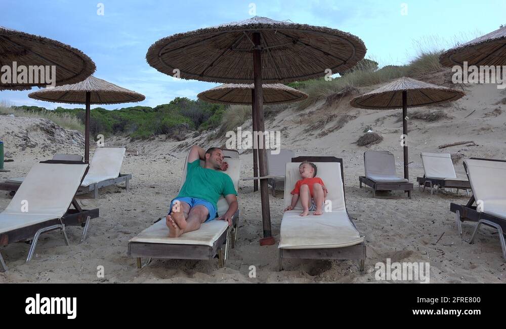Father and son relaxed discussion , friendly communication on the beach ...
