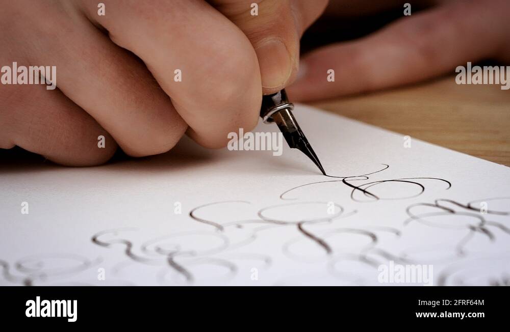 Writting letter with a pen. Calligraphy lesson. Close up. Slow motion ...