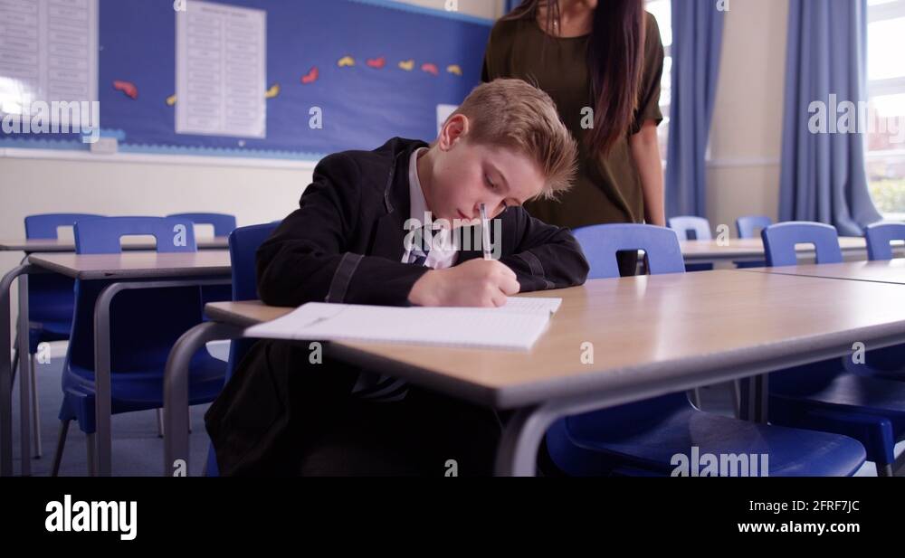4k, A teacher helping her student one on one with her work in the ...