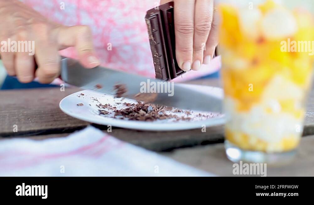 Grating chocolate to add shavings to fruit salad Stock Video Footage ...