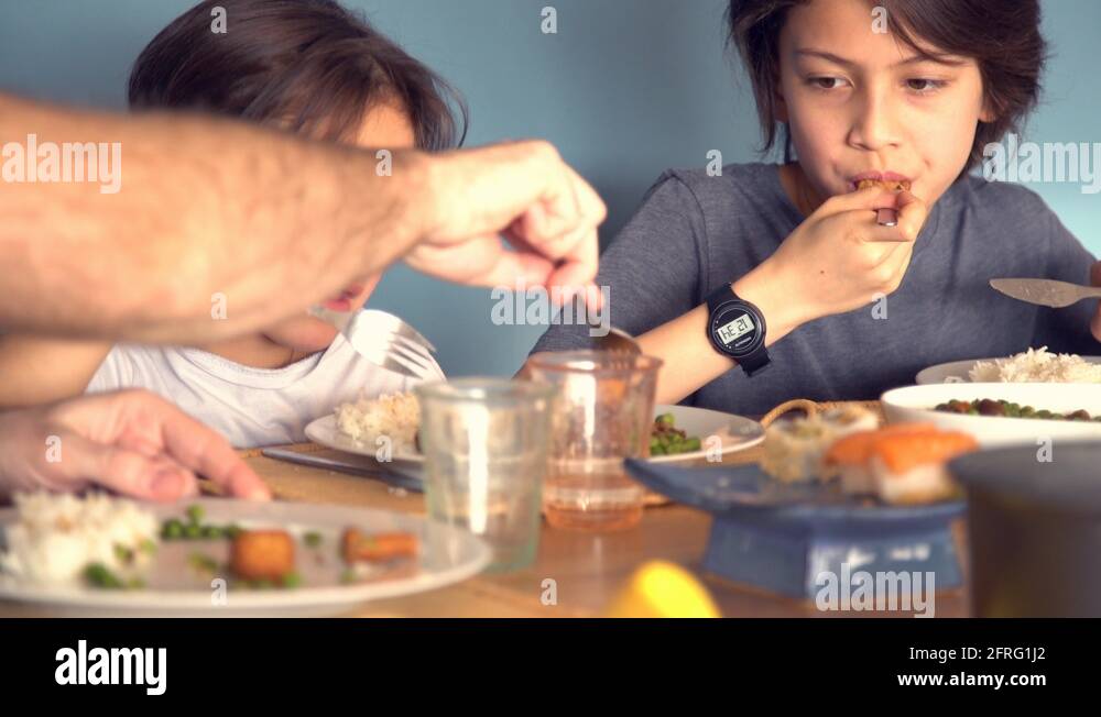 Father and daughter fighting over meatball at the dinner table Stock ...