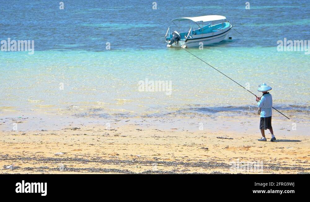 Local Man Carrying a Fishing Rod on a Balinese Tropical Beach. Video ...