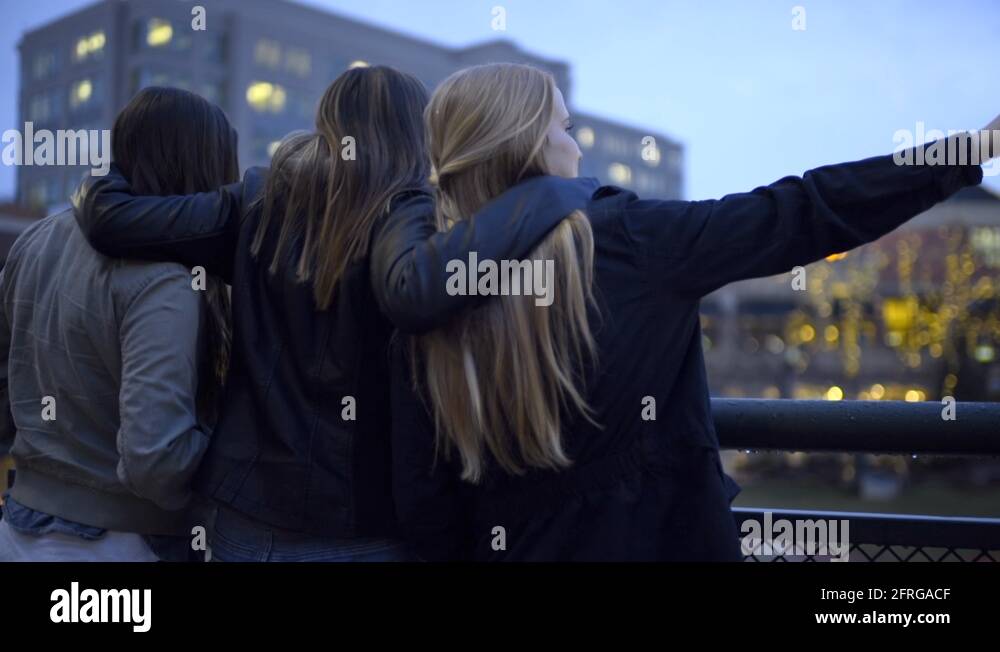Girls Take In City View From Balcony/Rooftop, Girl Raises Her Arm In ...