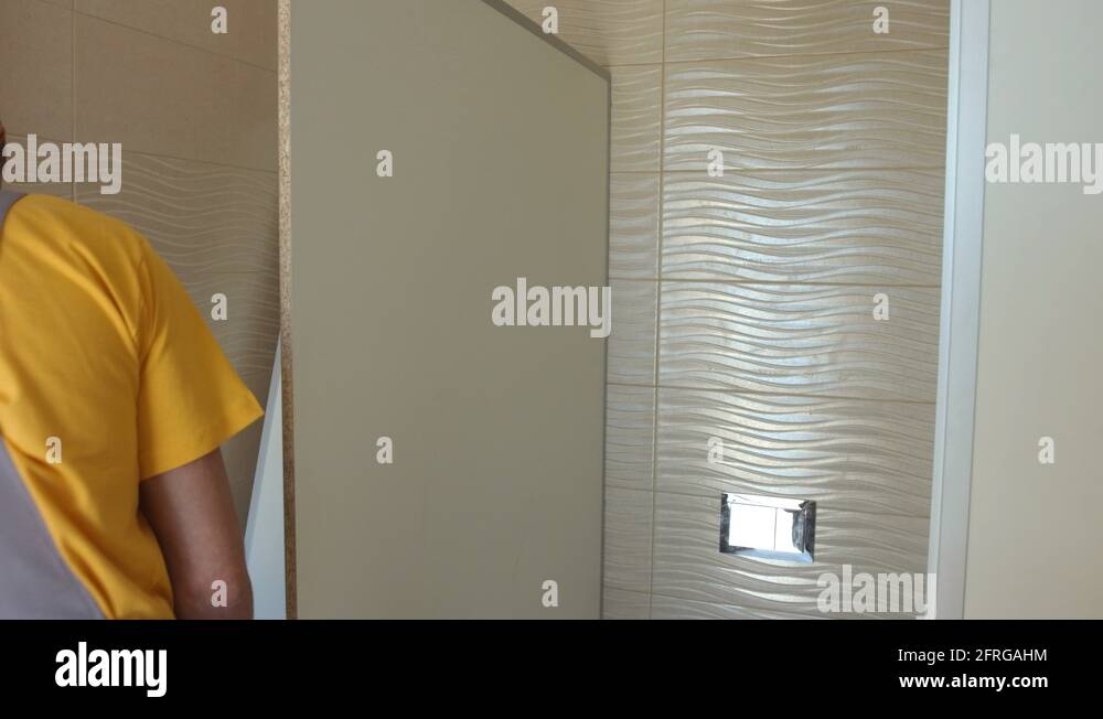 Two Men in Uniform Are Installing Partitions in Toilet Cubicles ...