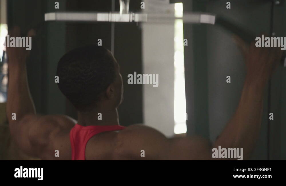 Black bodybuilder is training on apparatus in gym hall Stock Video ...