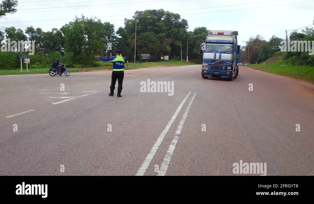 Policeman and traffic warden directing traffic flow at junction Stock ...