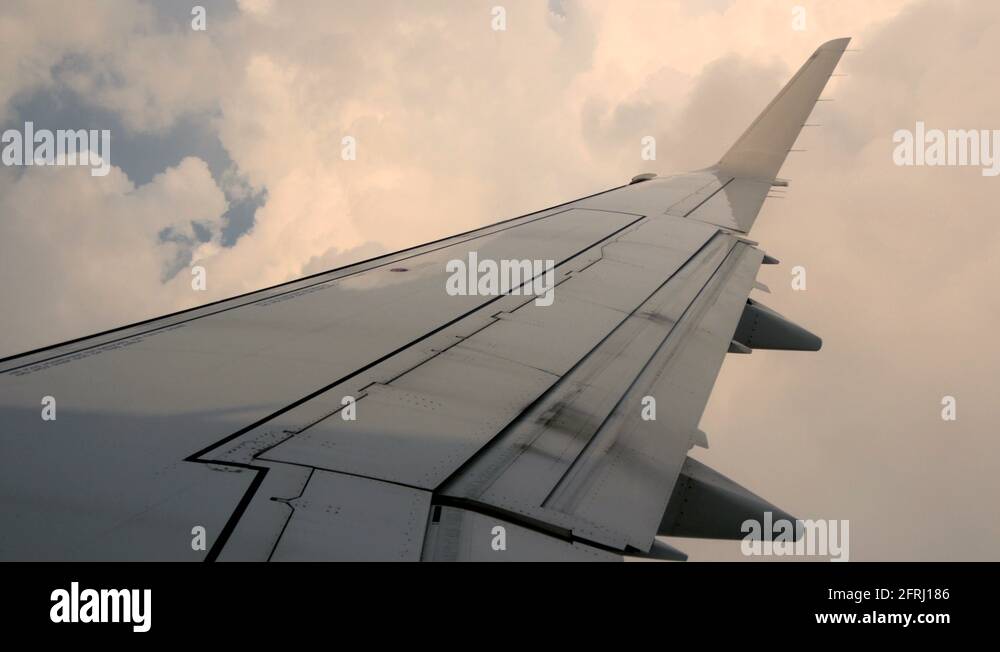 airplane window view. wing of plane. windy stormy flying conditions ...