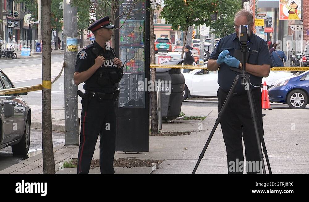 Police officers at shooting murder and crime scene in downtown Toronto ...