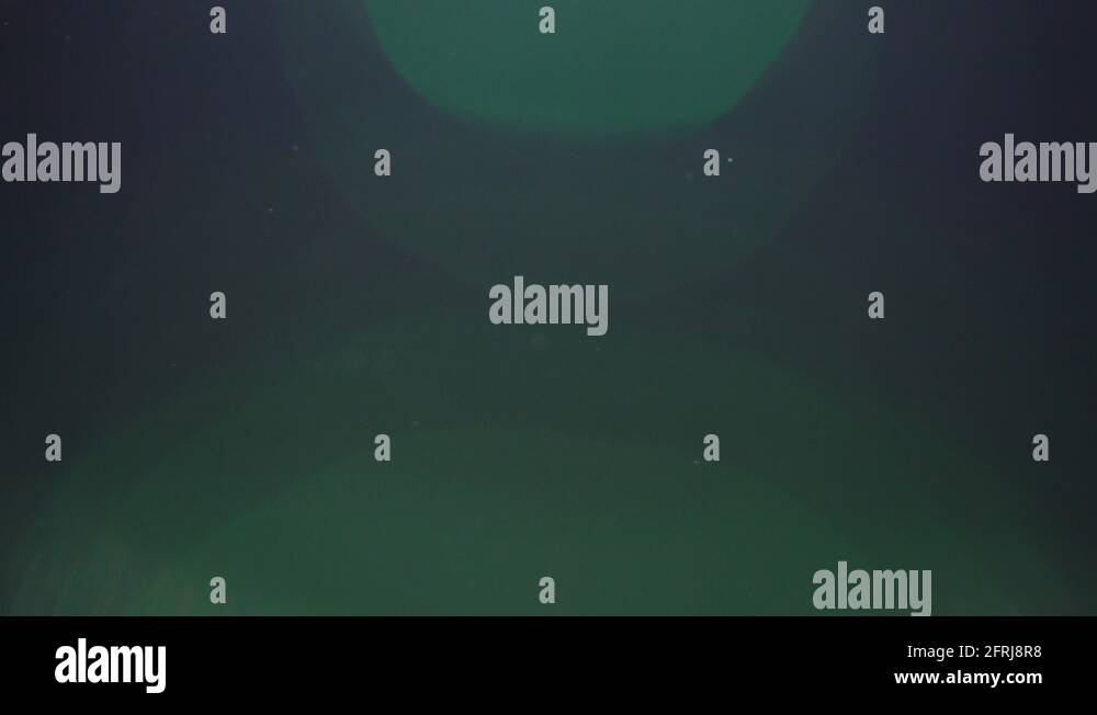green lens flare over black background blinking Stock Video Footage - Alamy