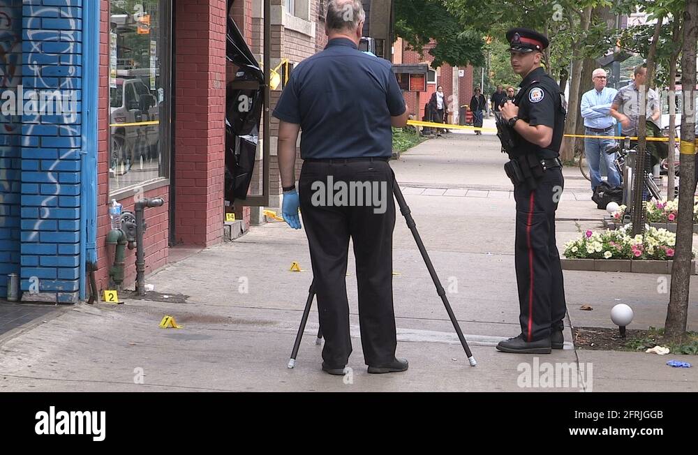 Police officers at shooting murder and crime scene in downtown Toronto ...