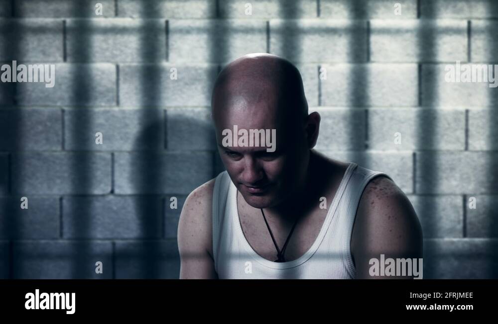 Sad Man Sitting In Jail Stock Video Footage - Alamy
