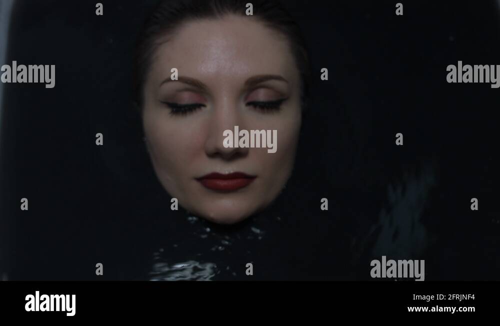 4k shoot of a horror Halloween model - Woman diving in black water ...