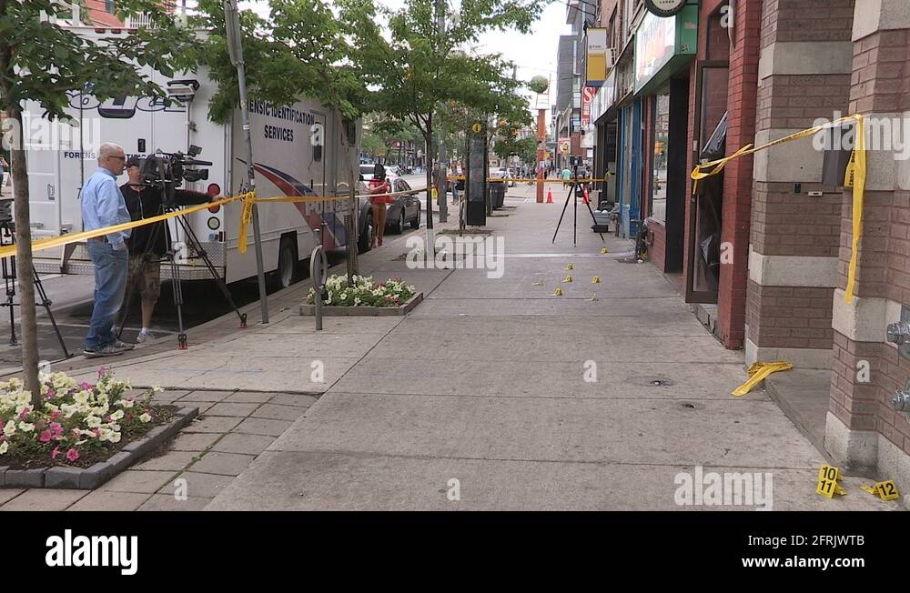Police officers at shooting murder and crime scene in downtown Toronto ...