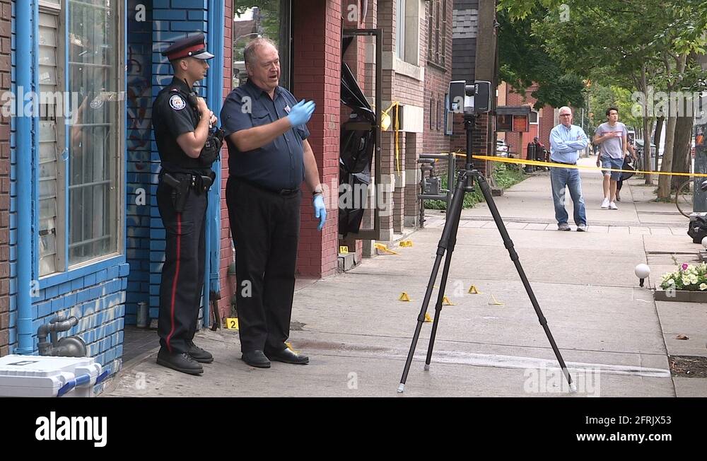 Police officers at shooting murder and crime scene in downtown Toronto ...