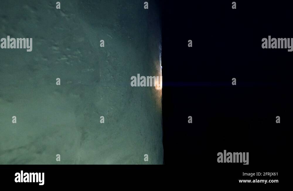 spooky mystery scene of person using flashlight to discover dark ice ...