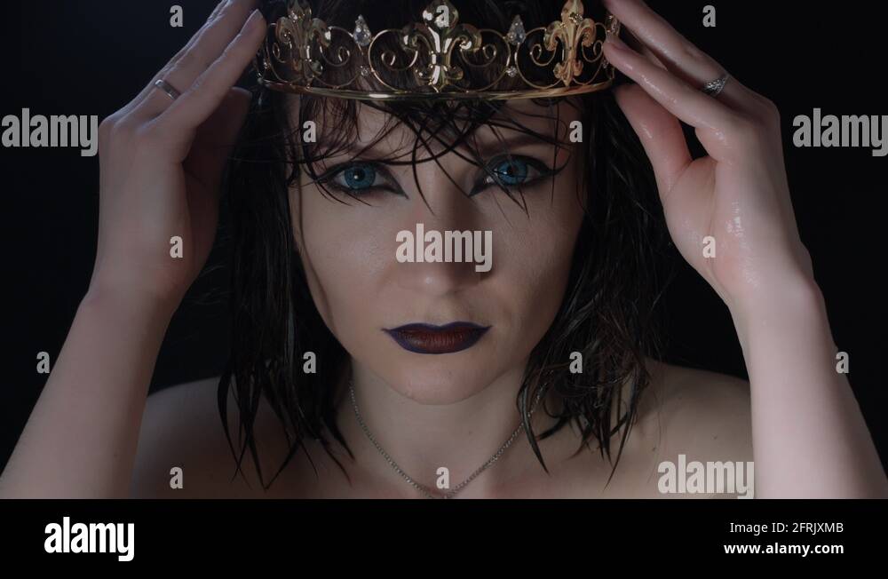 4k shoot of a horror Halloween model - Vampire putting crown on head ...