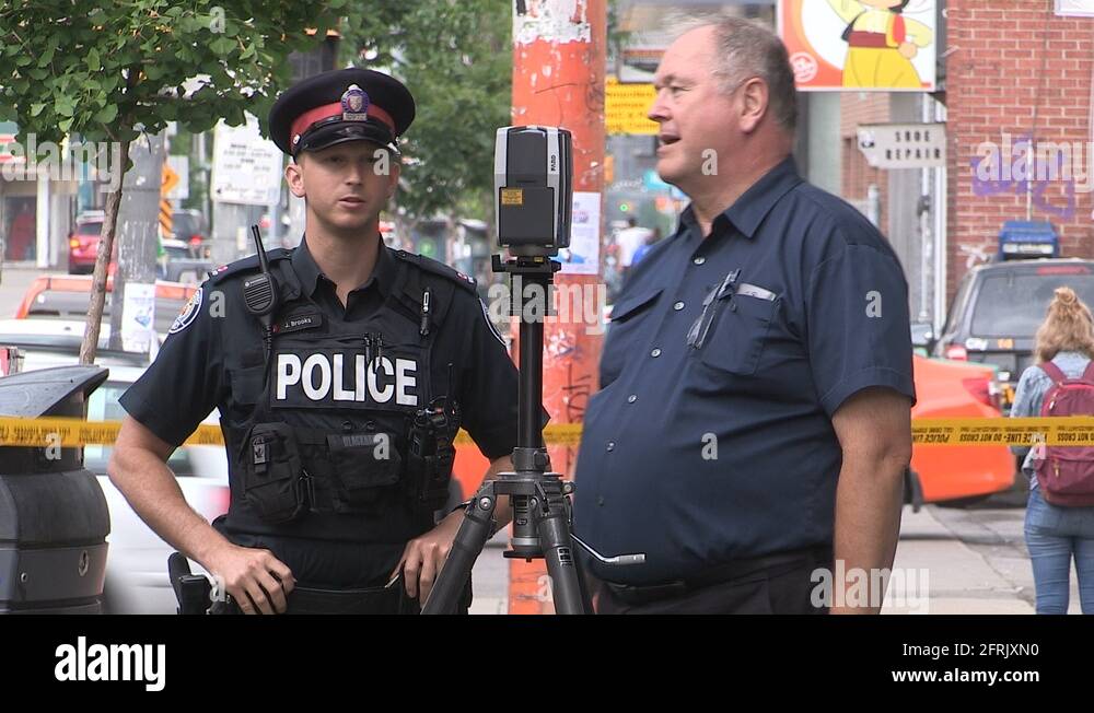 Police officers at shooting murder and crime scene in downtown Toronto ...