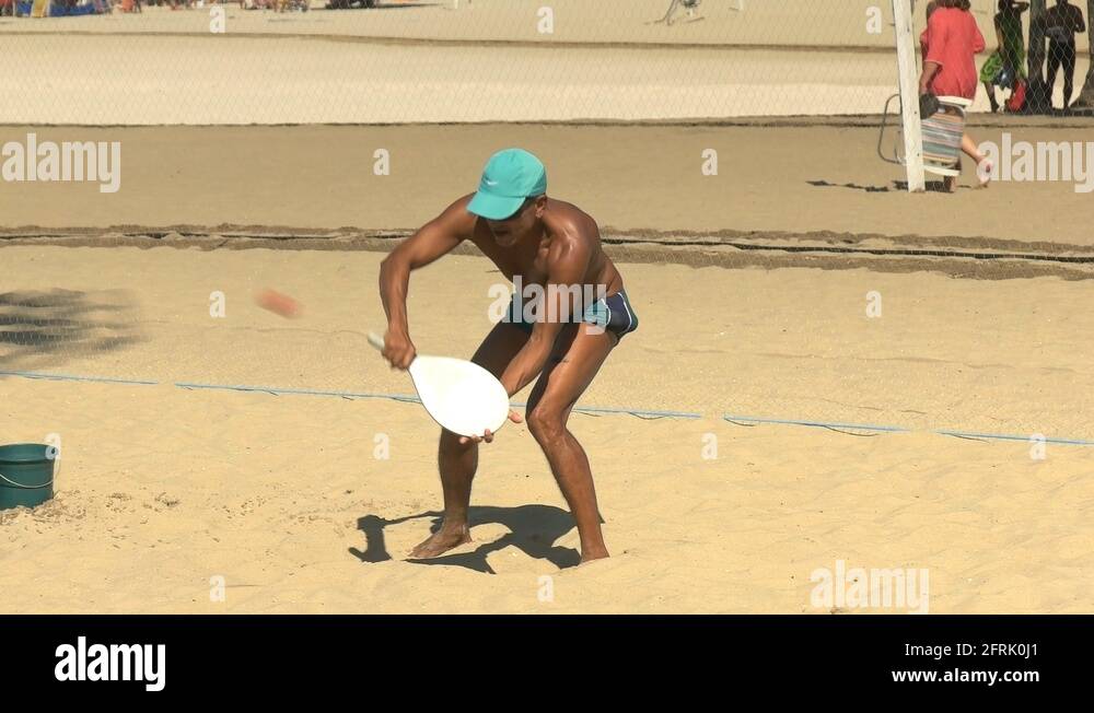 a player practices for a beach tennis game on copacabana beach in rio ...