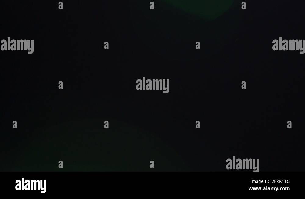 green lens flare over black background blinking Stock Video Footage - Alamy