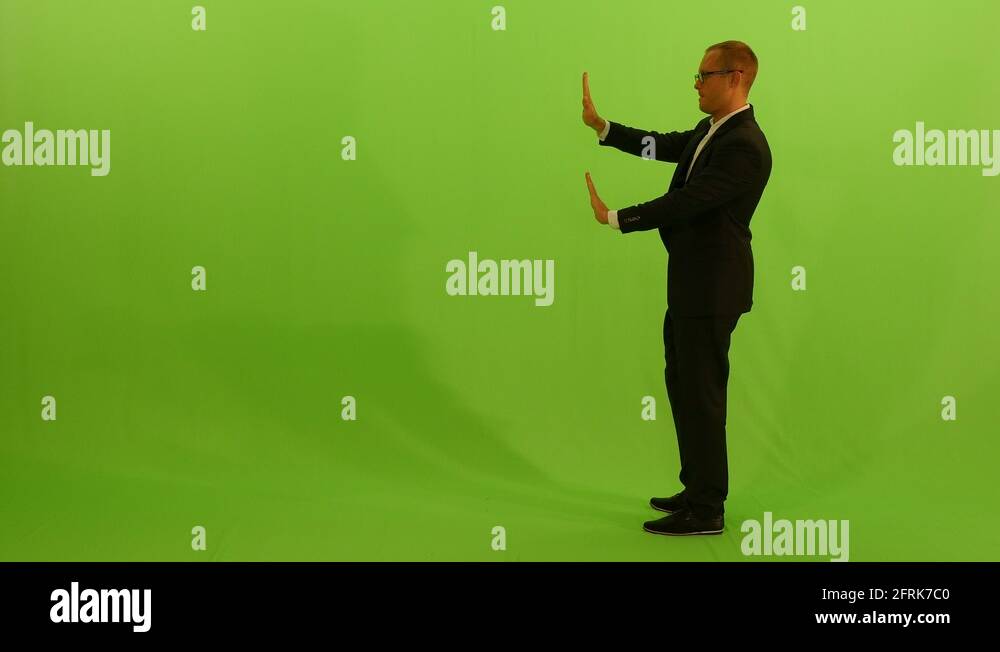 man moving object across the room. isolated green screen background ...