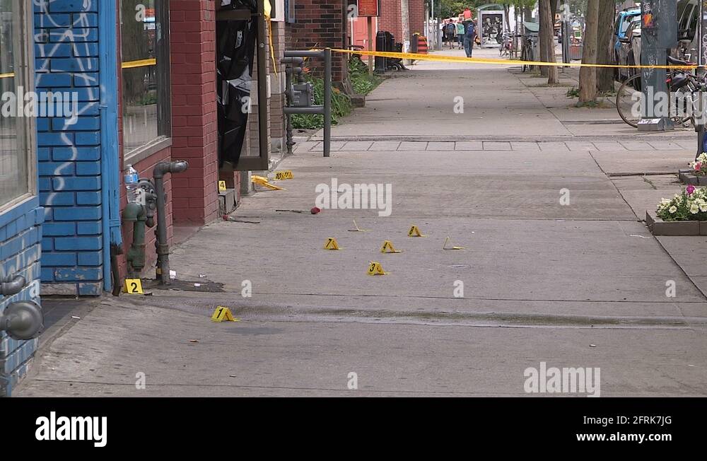 Police officers at shooting murder and crime scene in downtown Toronto ...