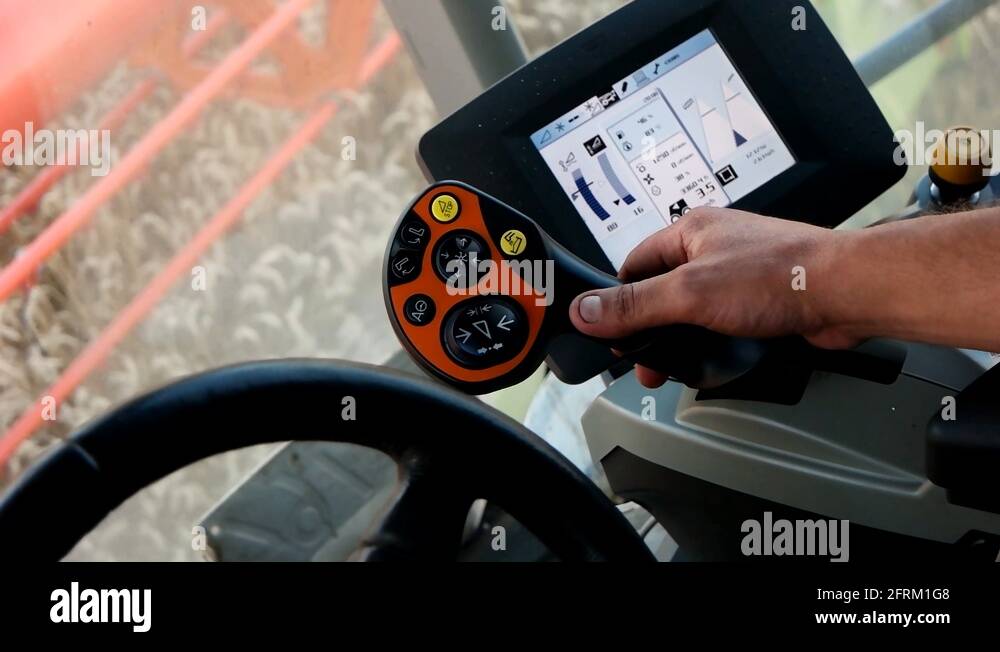 Man manages harvester combine harvester with a control panel Stock ...