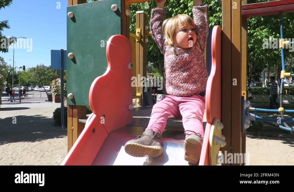 baby sliding in playground park Stock Video Footage - Alamy
